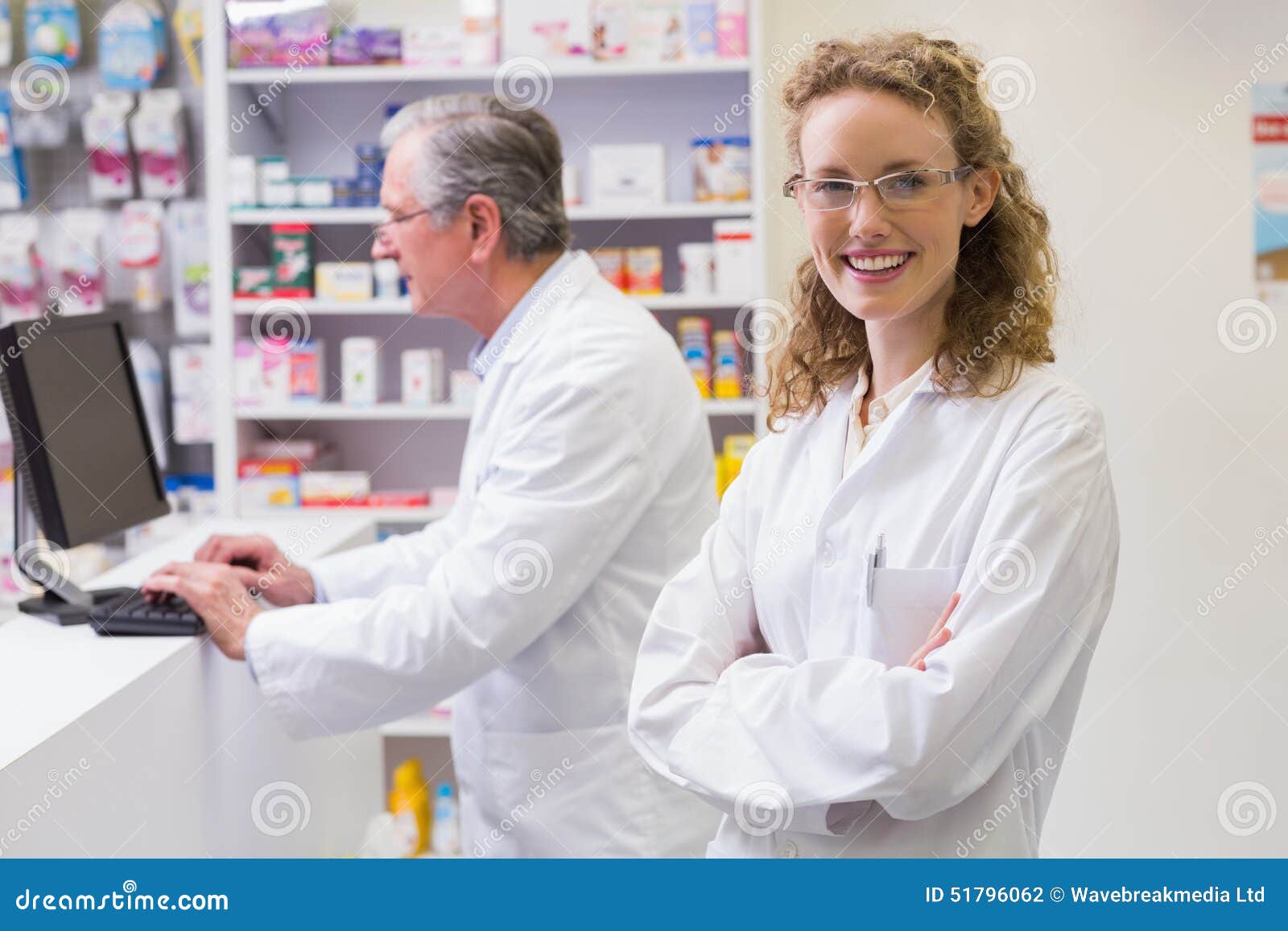Pharmacist Smiling at Camera Stock Photo - Image of arms, drugstore ...