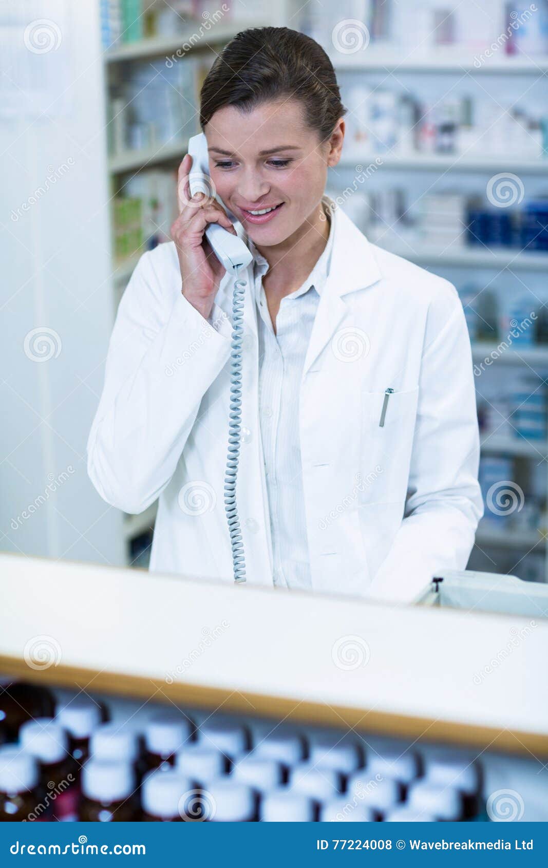 Pharmacist Standing at Counter and Talking on Phone Stock Photo - Image ...