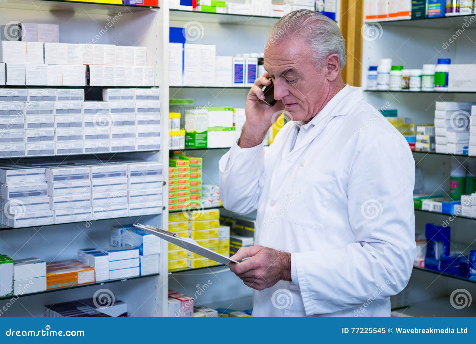 Pharmacist Talking on Mobile Phone while Checking Medicines Stock Image ...