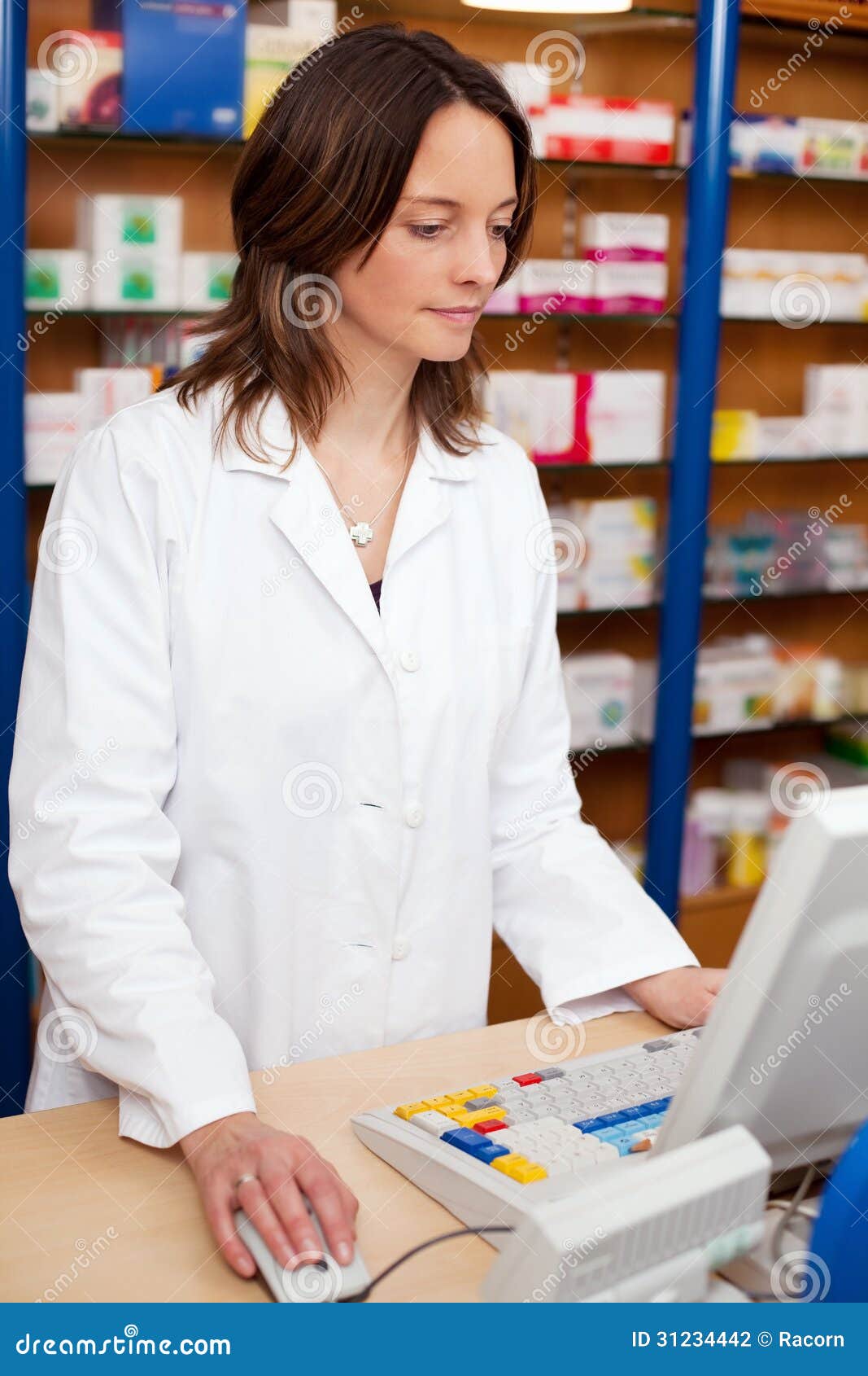 Pharmacist Using Computer at Counter Stock Photo - Image of bottle ...