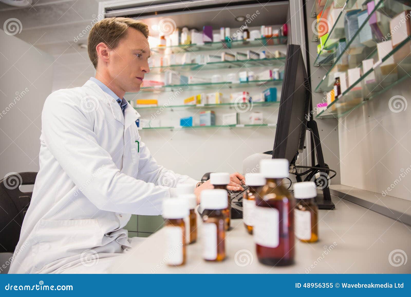 Pharmacist Using Computer at Desk Stock Image - Image of medicament ...