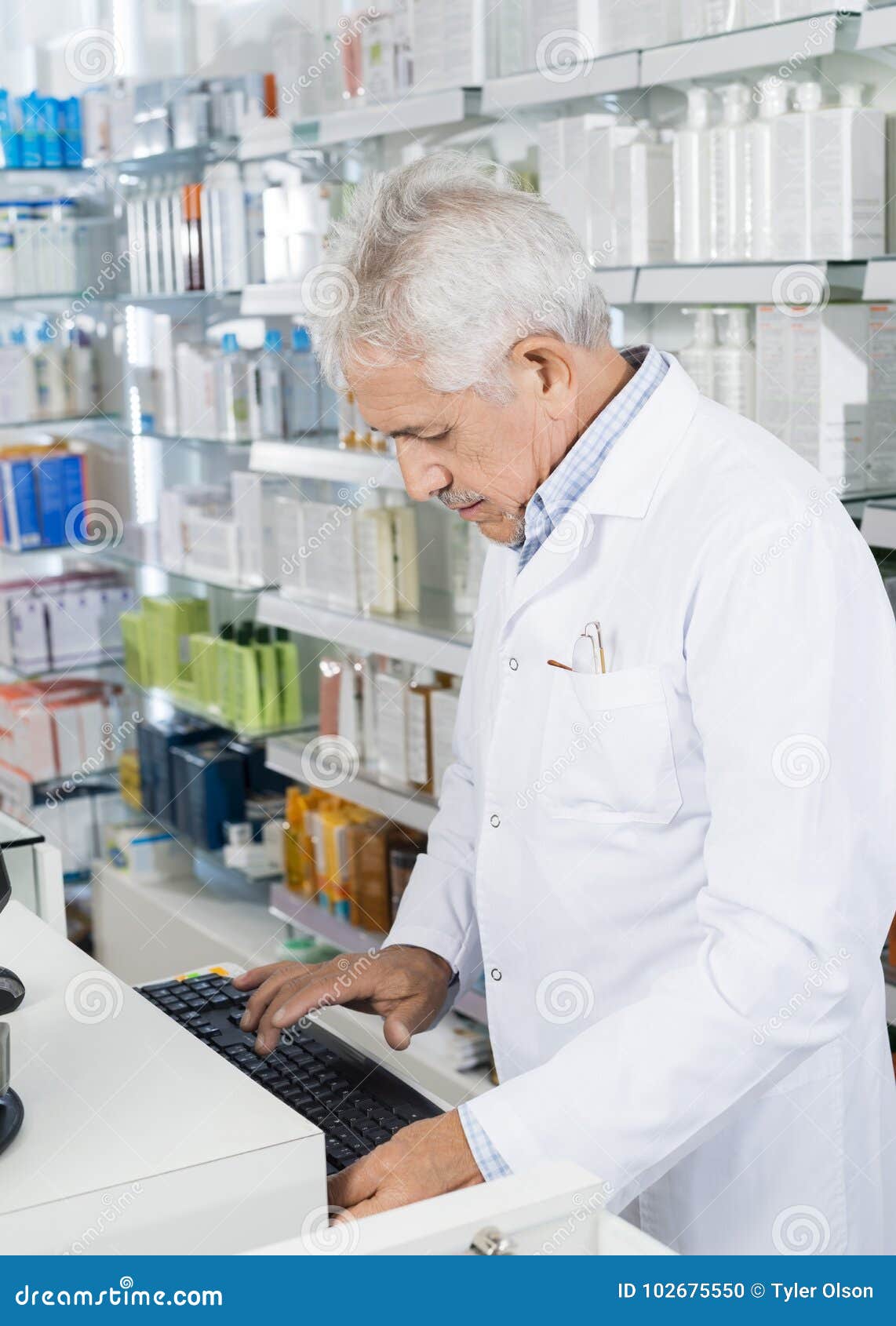 Pharmacist Using Computer Keyboard at Counter Stock Photo - Image of ...
