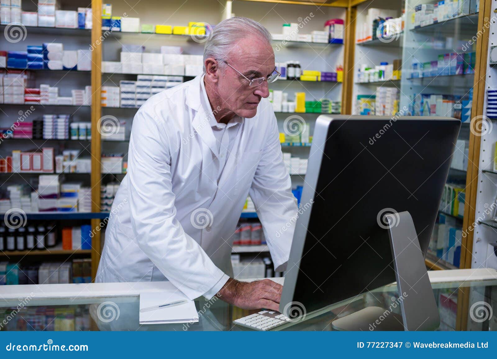Pharmacist using computer stock image. Image of pharmaceutics - 77227347
