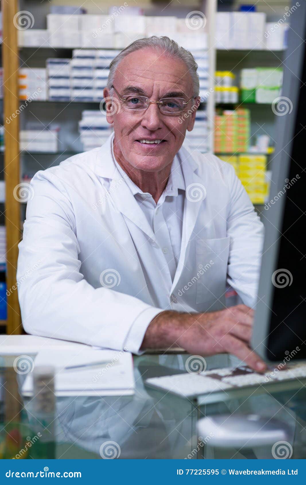 Pharmacist using computer stock image. Image of dispensary - 77225595