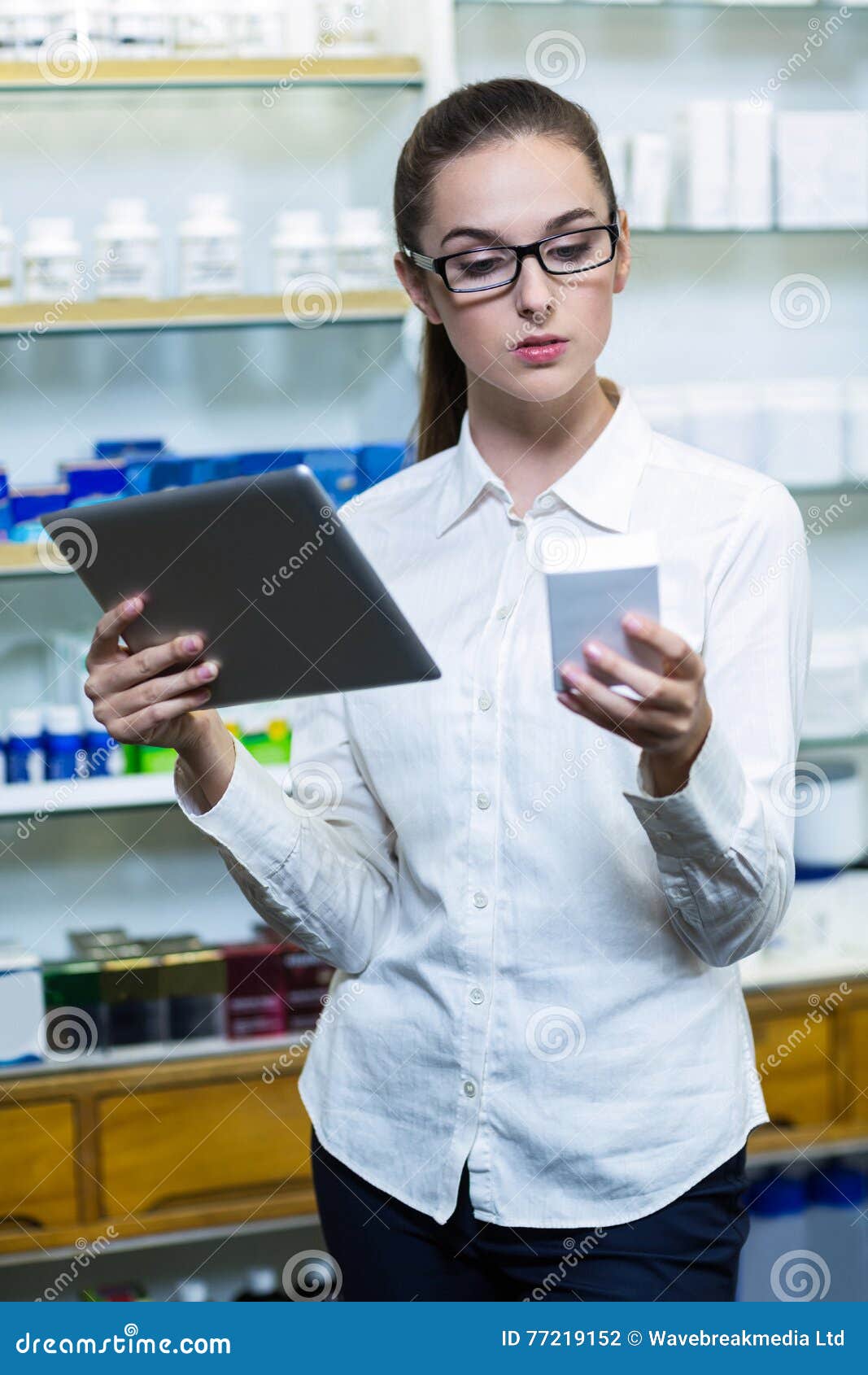 Pharmacist Using Digital Tablet while Checking Medicine Stock Photo ...