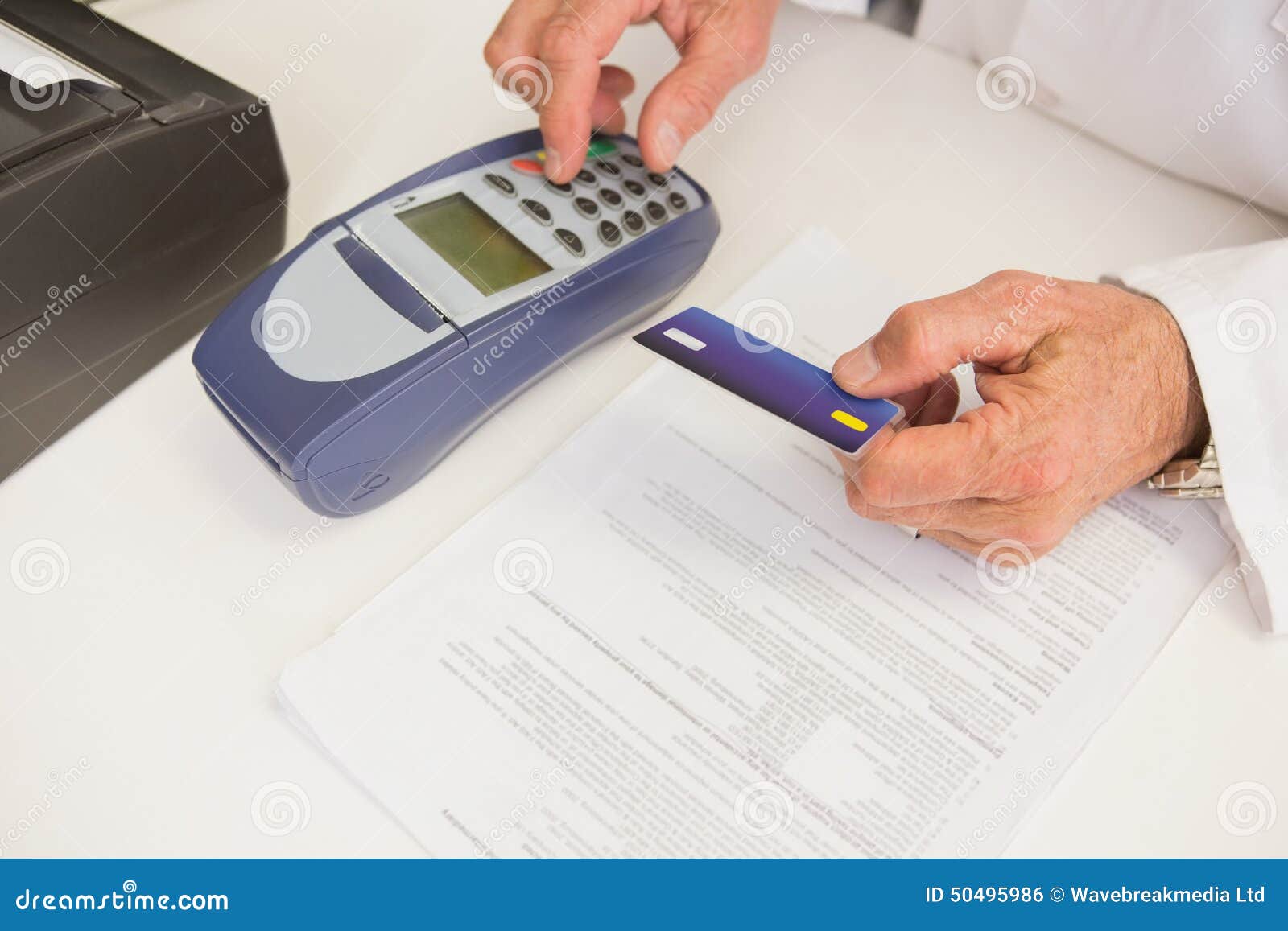Pharmacist Using Keypad and Holding Credit Card Stock Photo - Image of ...