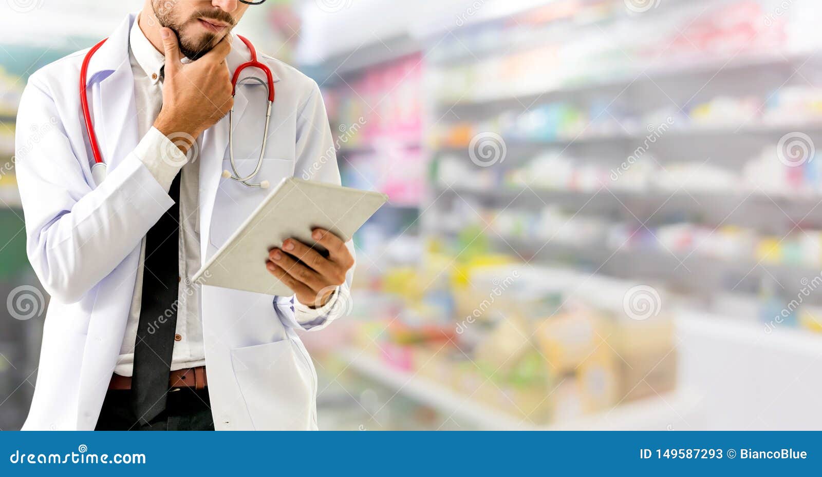 Pharmacist Using Tablet Computer at Pharmacy Stock Image - Image of ...