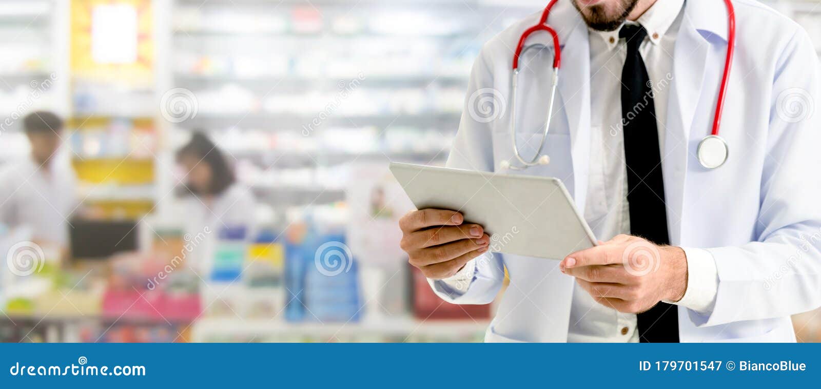 Pharmacist Using Tablet Computer at Pharmacy Stock Image - Image of ...