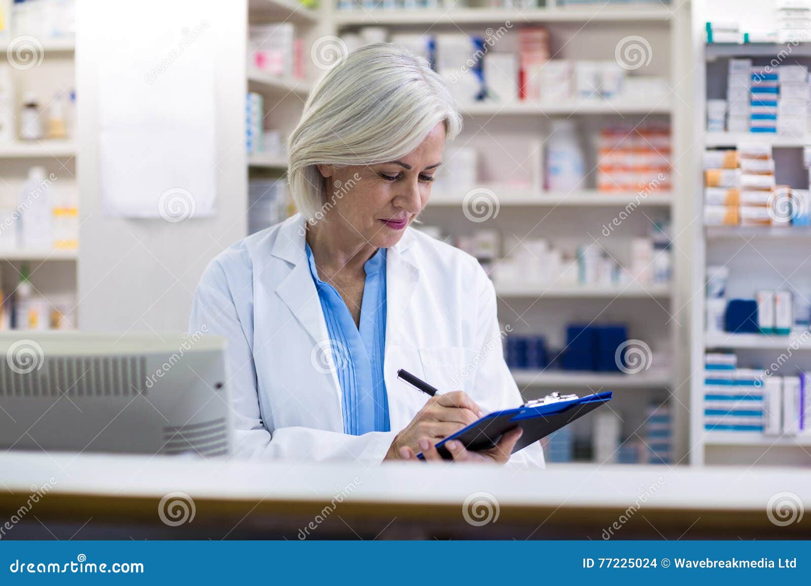 Pharmacist Writing on Clipboard Stock Photo - Image of checking, coat ...