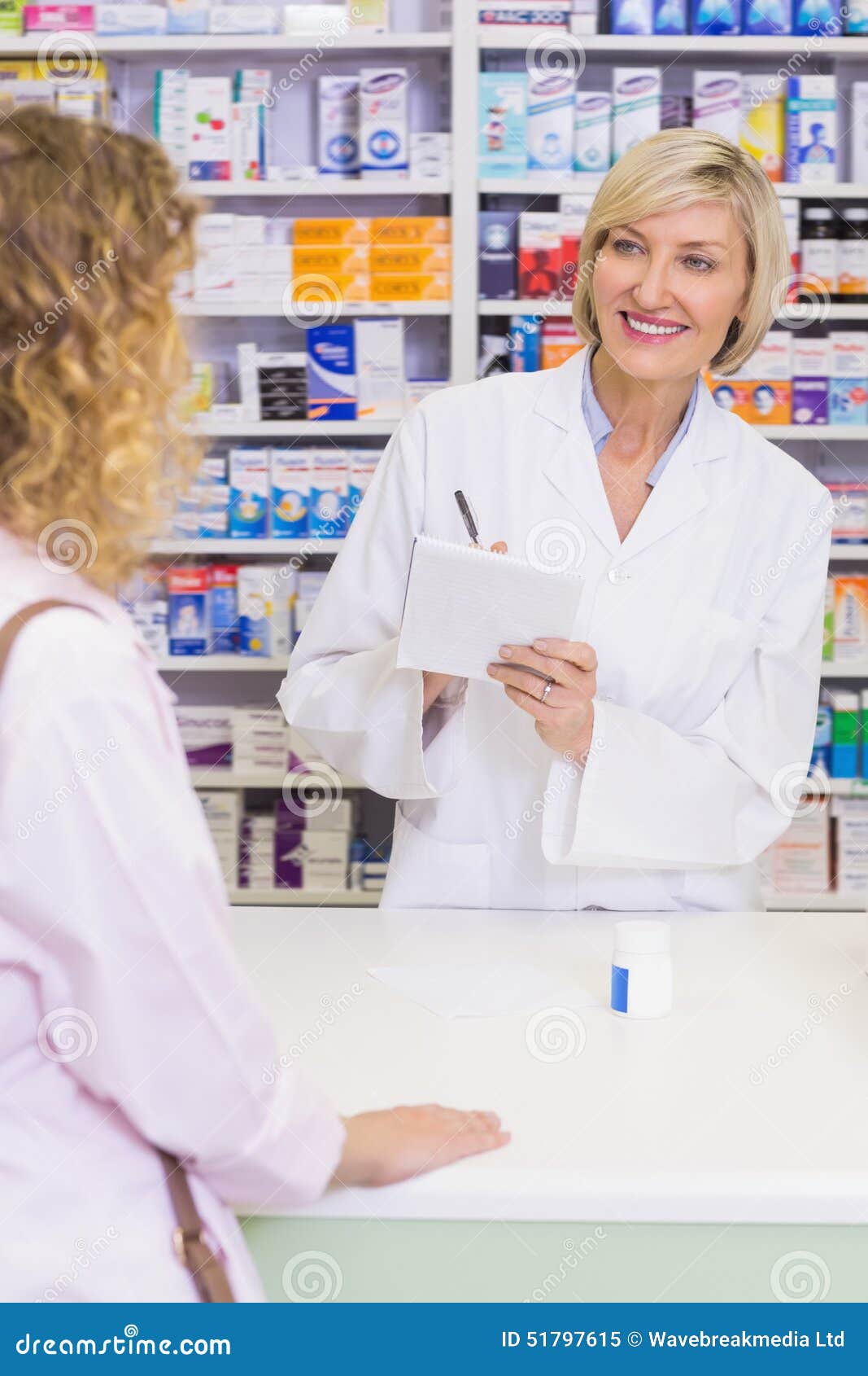 Pharmacist Writing Prescription in Front of a Customer Stock Image ...
