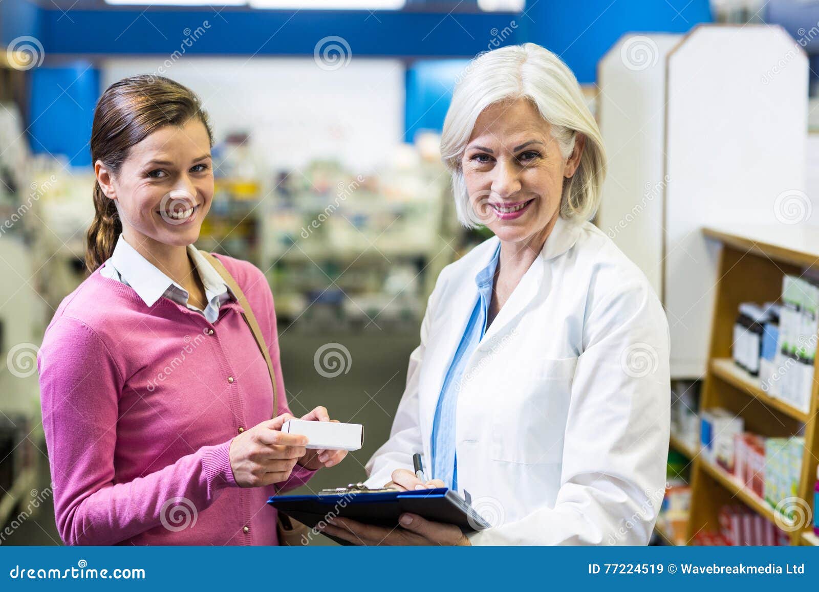 Pharmacist Writing Prescriptions for Customer on Clipboard in Pharmacy ...