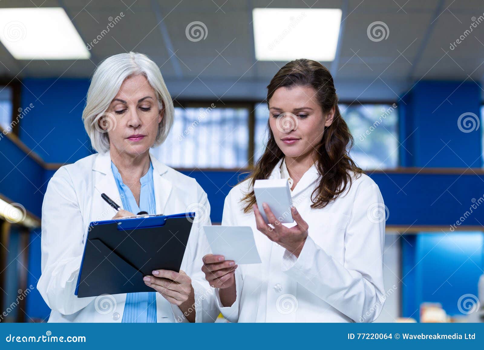 Pharmacists Checking and Writing Prescription for Medicine Stock Photo ...
