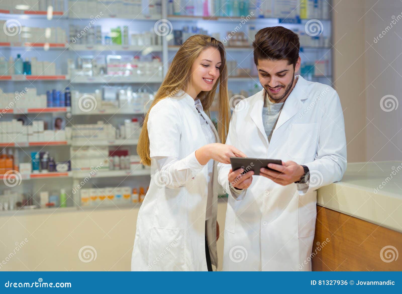 Pharmacists Using Digital Tablet while Checking Medicine Stock Photo ...