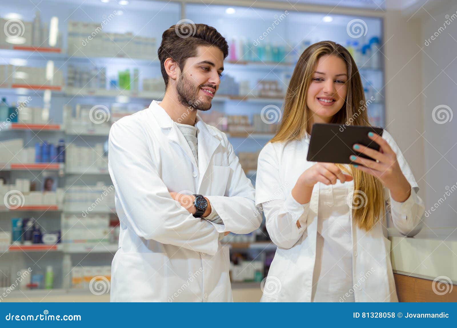 Pharmacists Using Digital Tablet while Checking Medicine Stock Photo ...