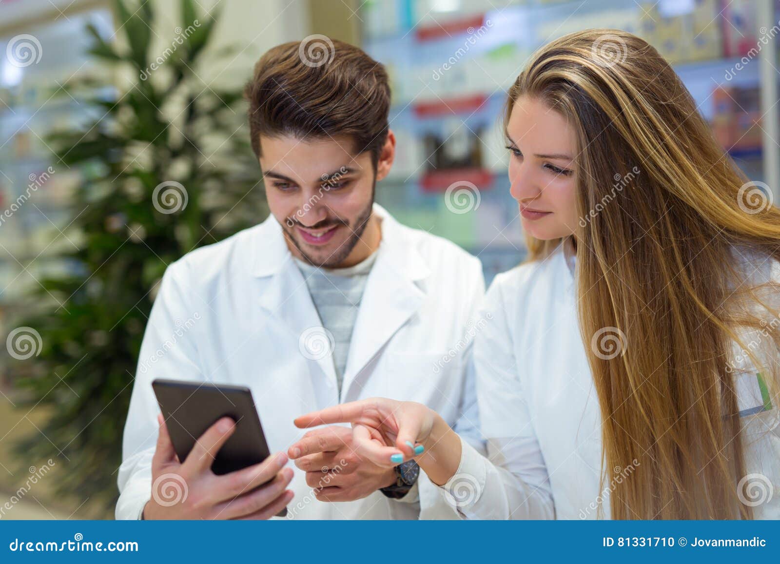 Pharmacists Using Digital Tablet while Checking Medicine Stock Photo ...
