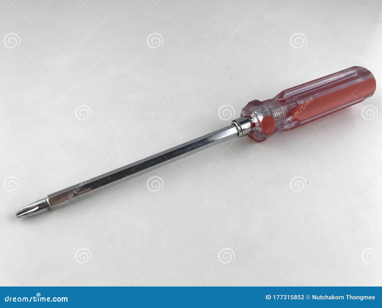 A Phillips-shaped Screwdriver with a Red Plastic Handle Placed on a ...