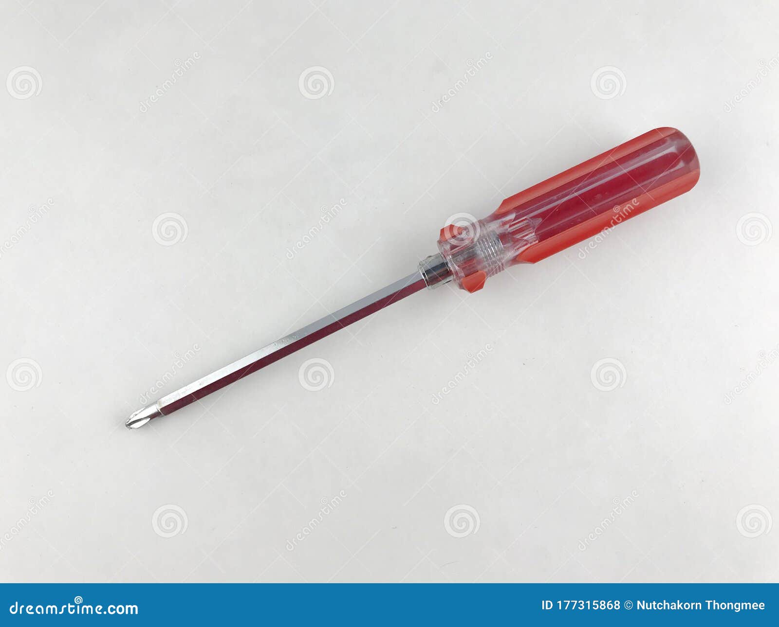 A Phillips-shaped Screwdriver with a Red Plastic Handle Placed on a ...
