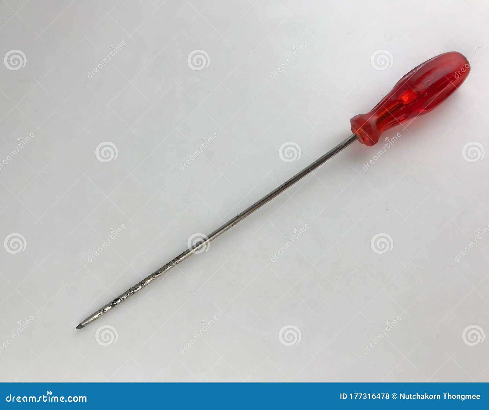 A Phillips-shaped Screwdriver with a Red Plastic Handle Placed on a ...