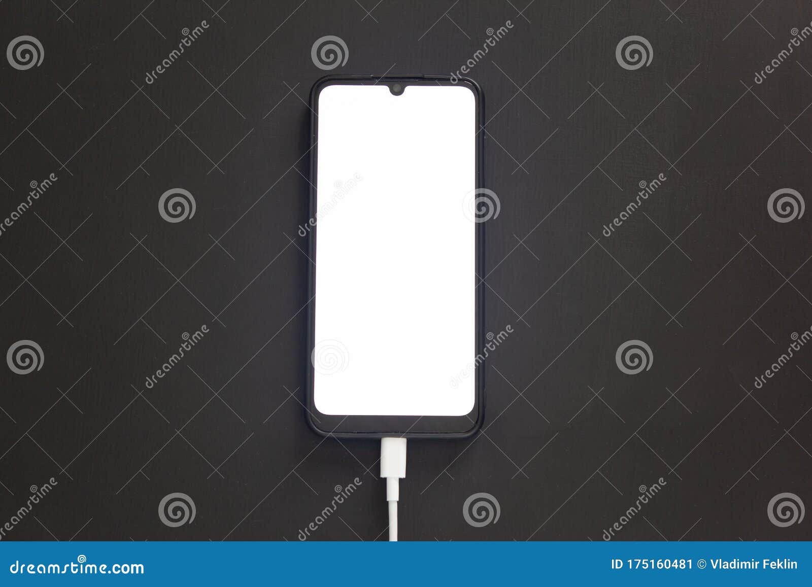 The Phone on a Black Background with a Luminous Screen is Charging ...