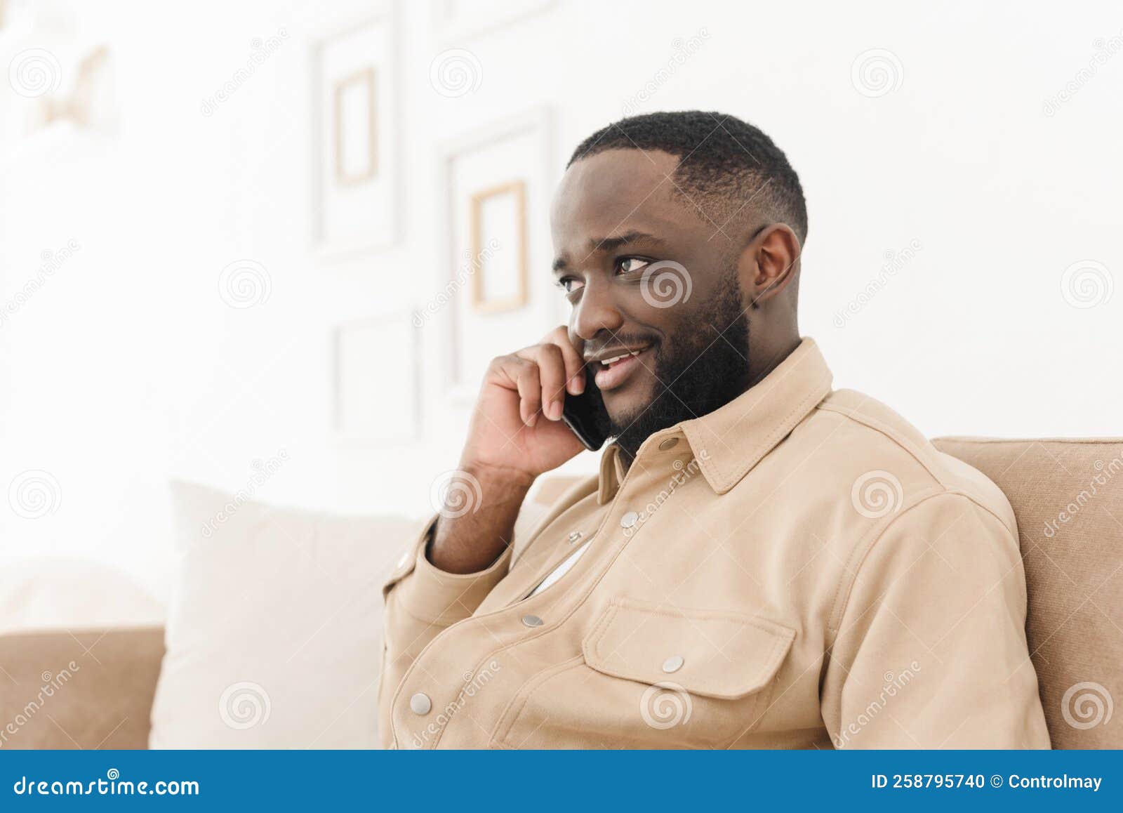Phone Call. Happy Afro Man Talking on Mobile Phone while Sittng on Sofa ...