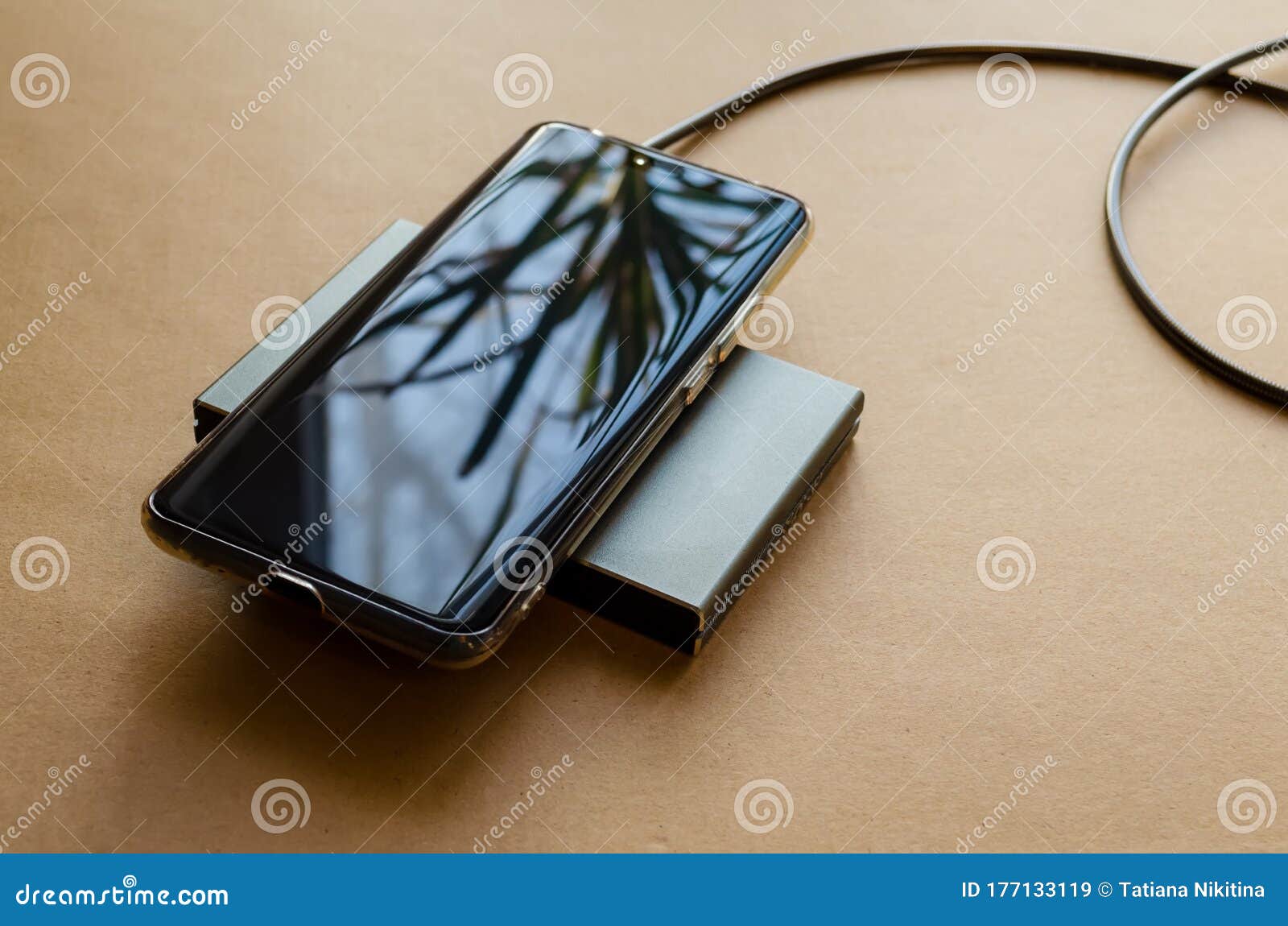 A Phone is Charging from a Rectangular Induction Charger. Wireless ...