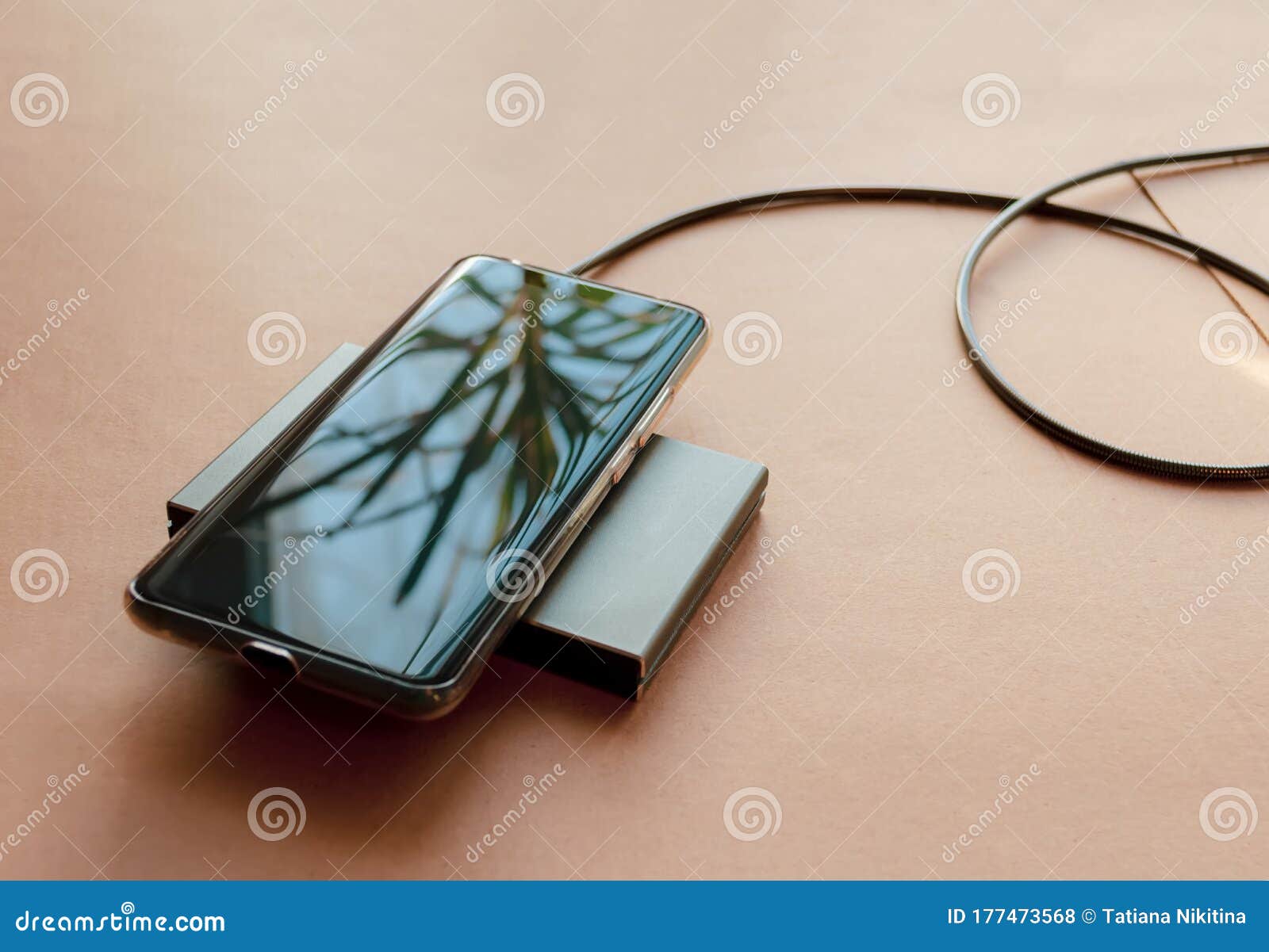 A Phone is Charging from a Rectangular Induction Charger. Wireless ...