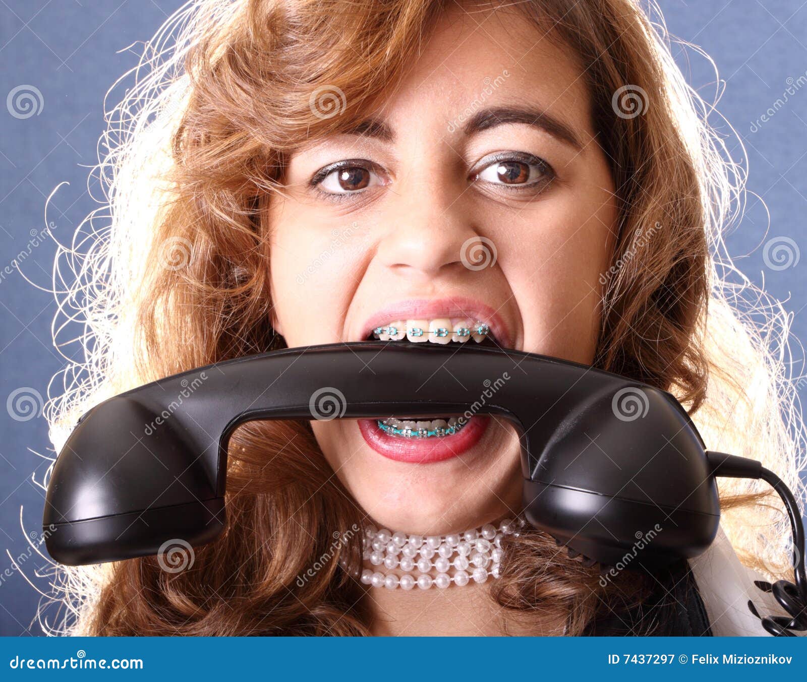 Phone in the mouth stock image. Image of open, braces - 7437297