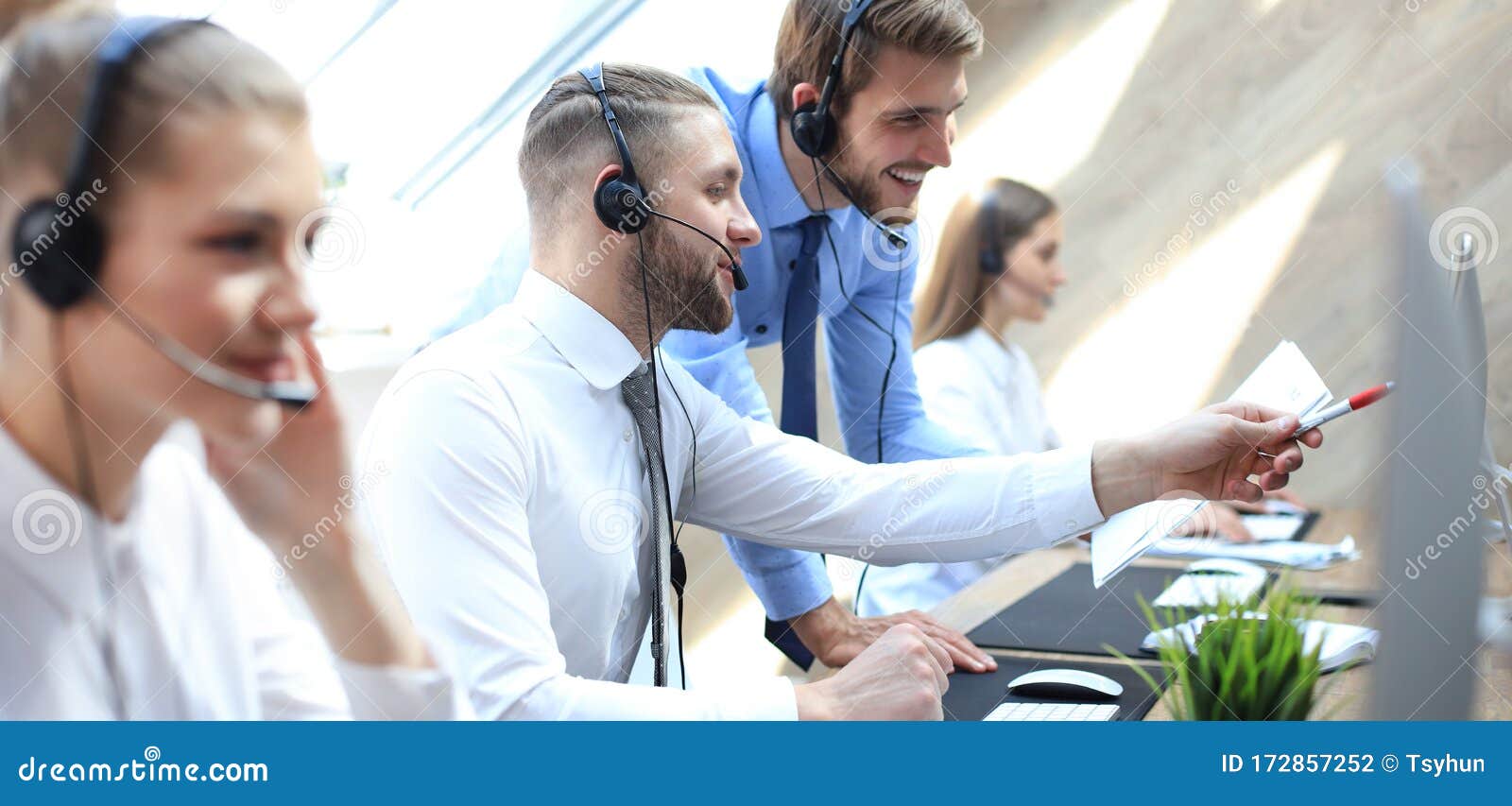 Phone Operator Working at Call Centre Office Helping His Colleague ...