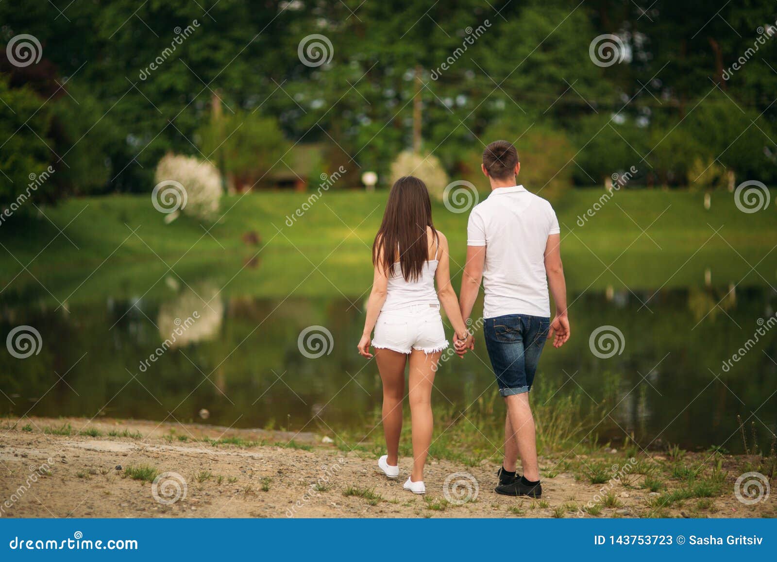 Photo of Back. Couple Hold Heir Hands in Back Pockets Stock Image ...