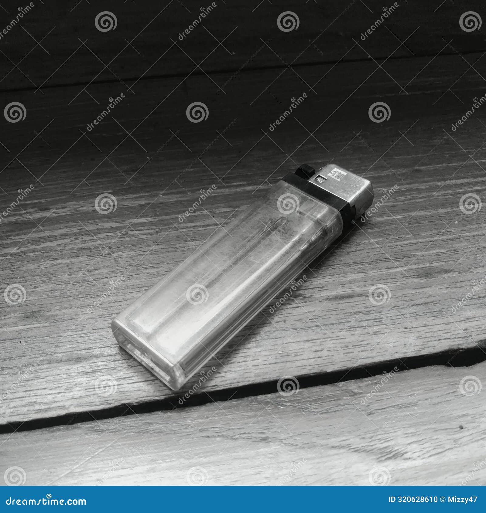Photo of Black and White Lighter Lay Down on the Wood Table Stock Photo ...