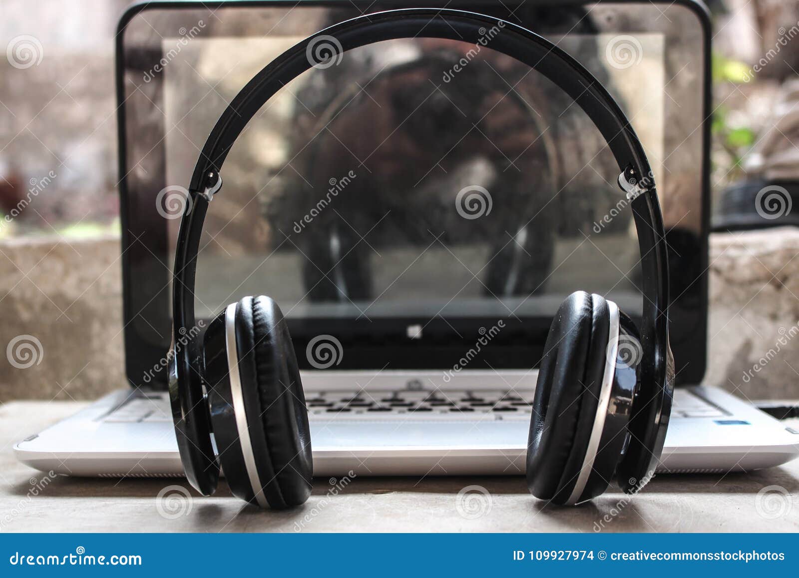 Photo Of Black Wireless Headphones In Front Of The Laptop Picture ...