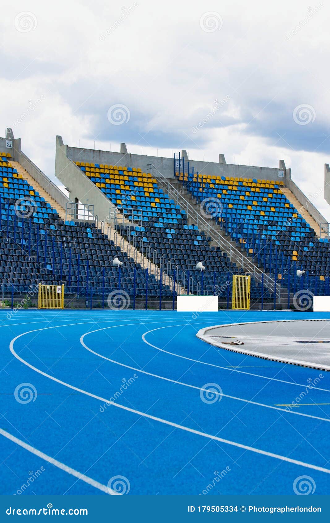 Photo of Blue Tracking Field on Stadium Stock Photo - Image of seats ...