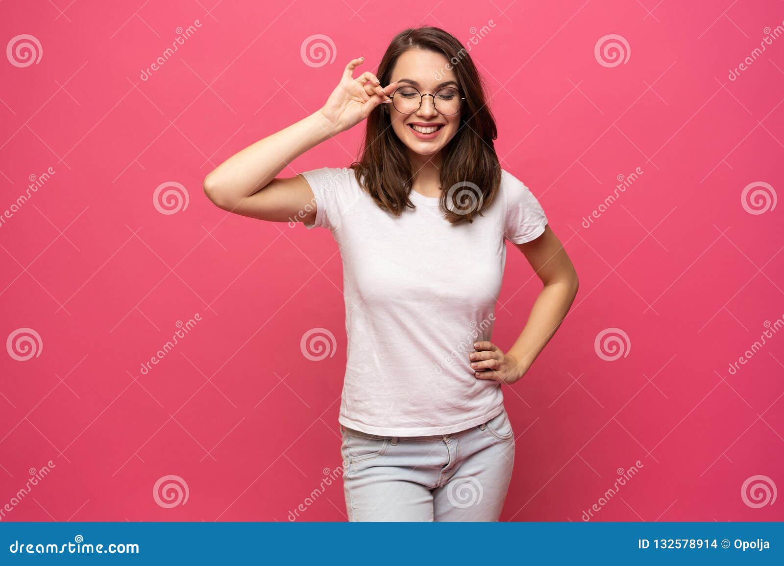 Photo Of Cheerful Beautiful Young Woman Standing Isolated Over Pink