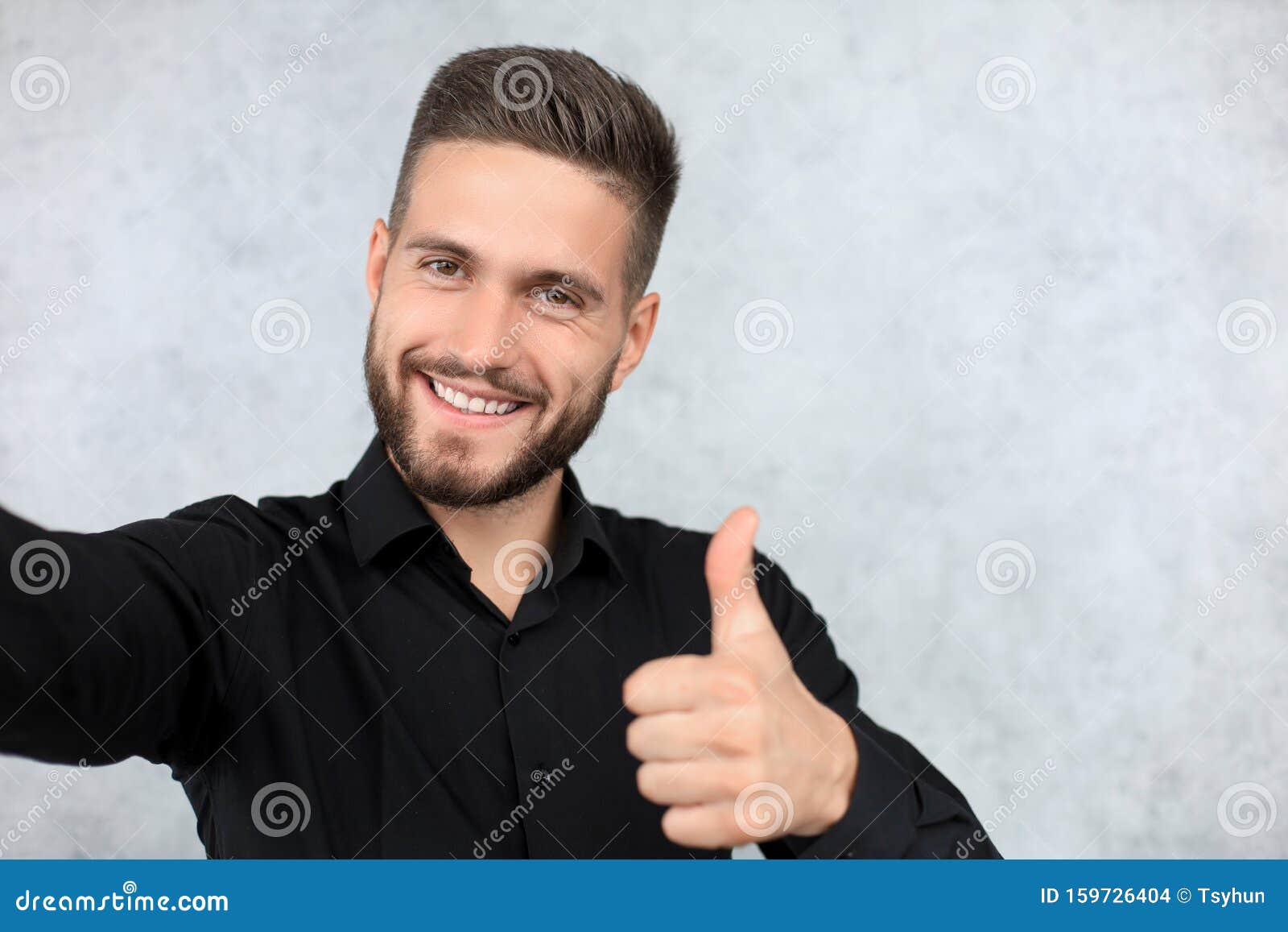 Photo Of Cheerful Handsome Young Man Standing Over Grey Background