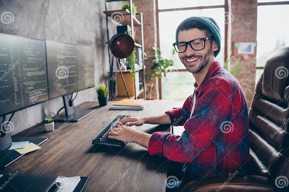 Photo of Cheerful Positive Coder Dressed Hat Glasses Smiling Writing ...