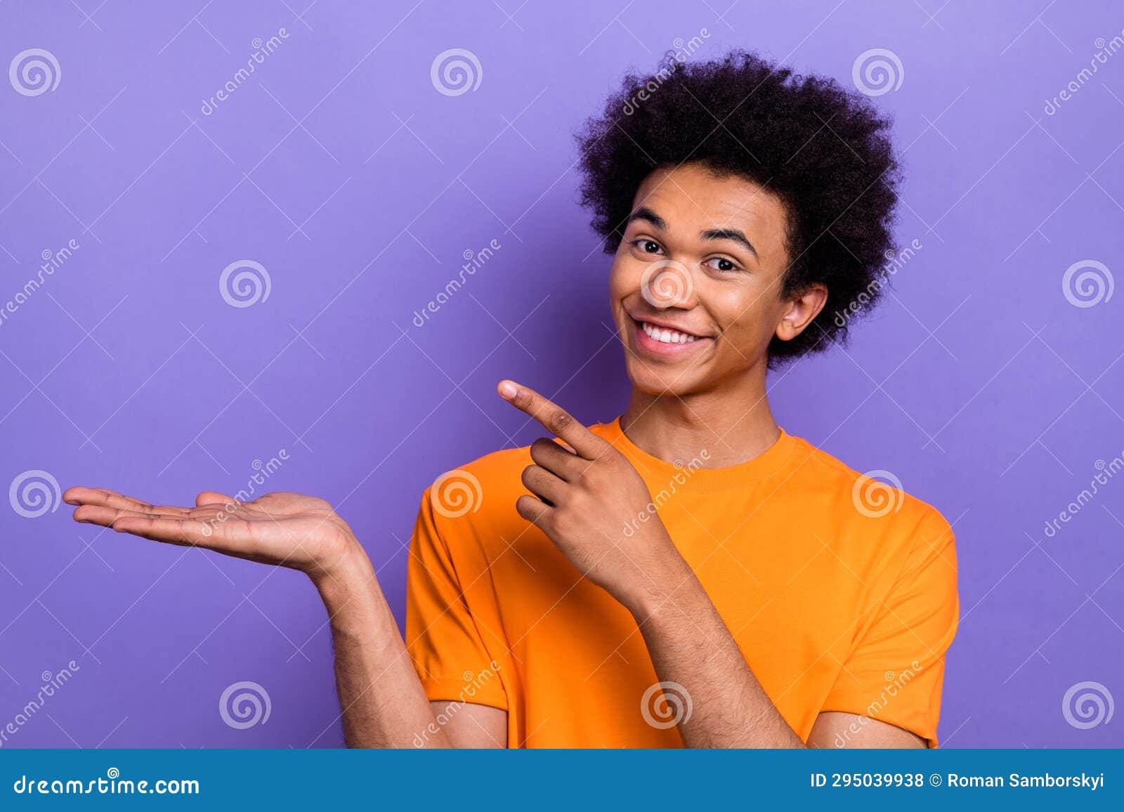 Photo Of Cheery Young Guy Wear Orange T Shirt Point Finger Empty Space