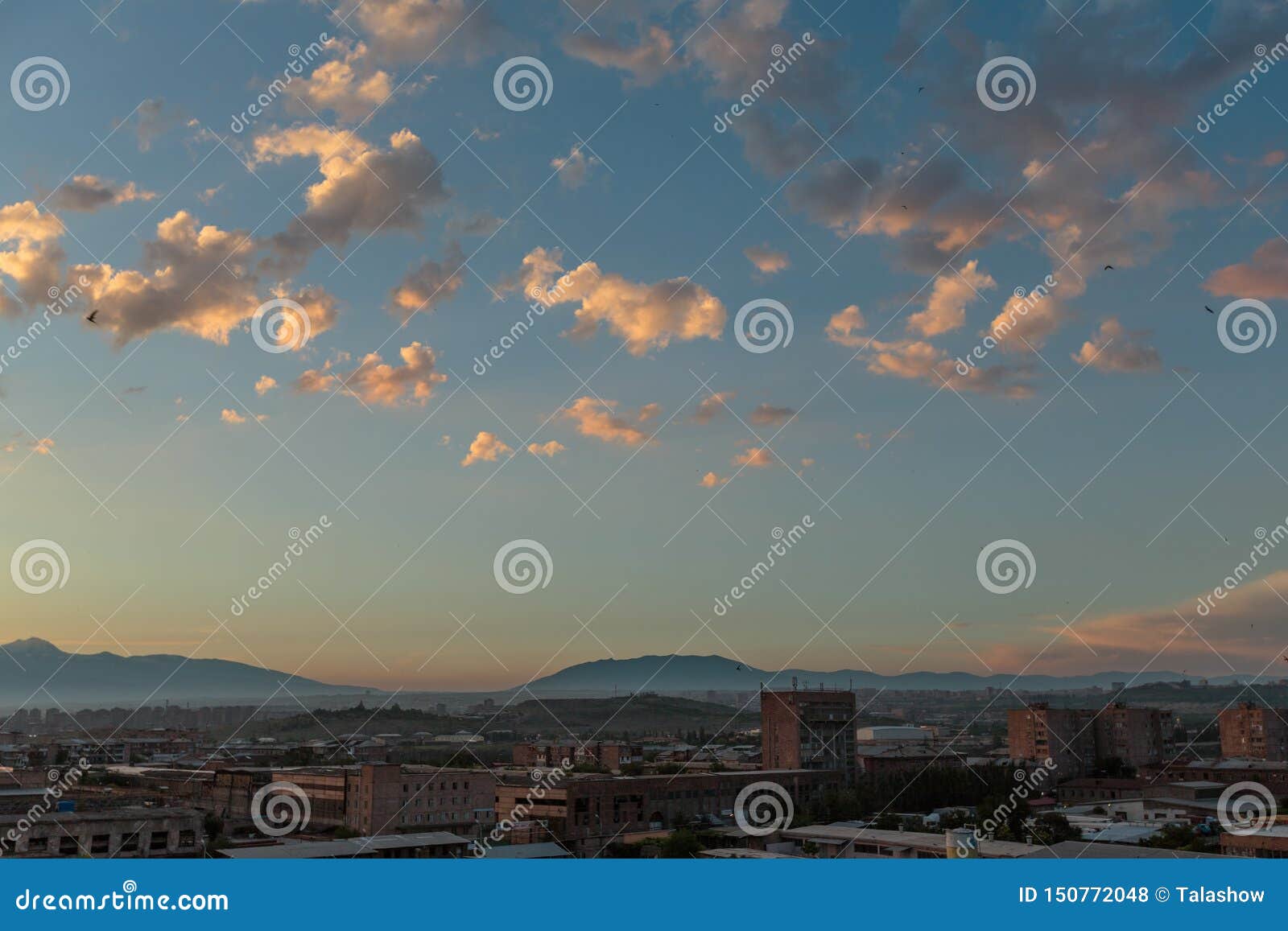 Photo of Clouds and Infrastructure of a Small Town Stock Photo - Image ...