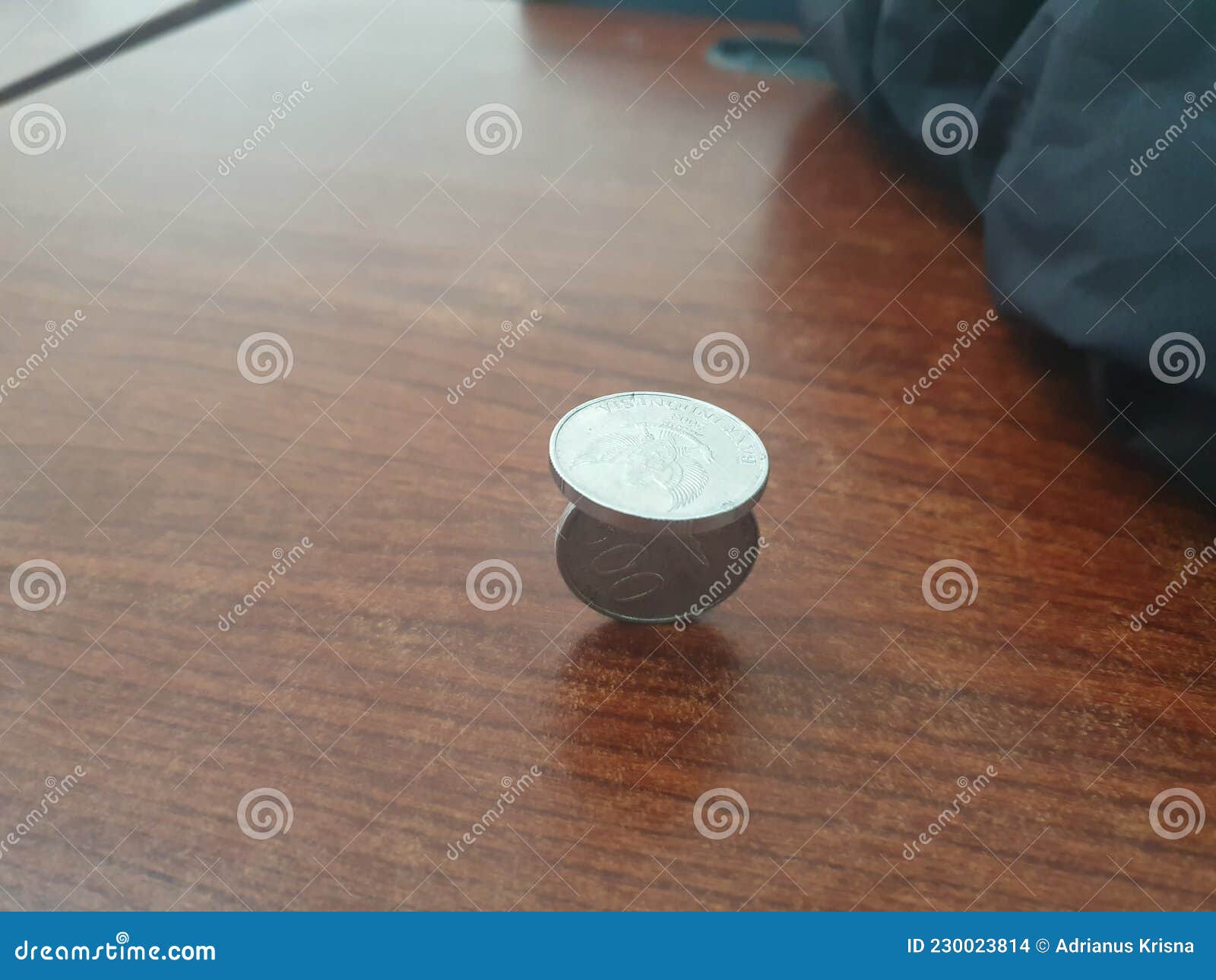 Coin Balancing on a Table stock photo. Image of hand - 230023814