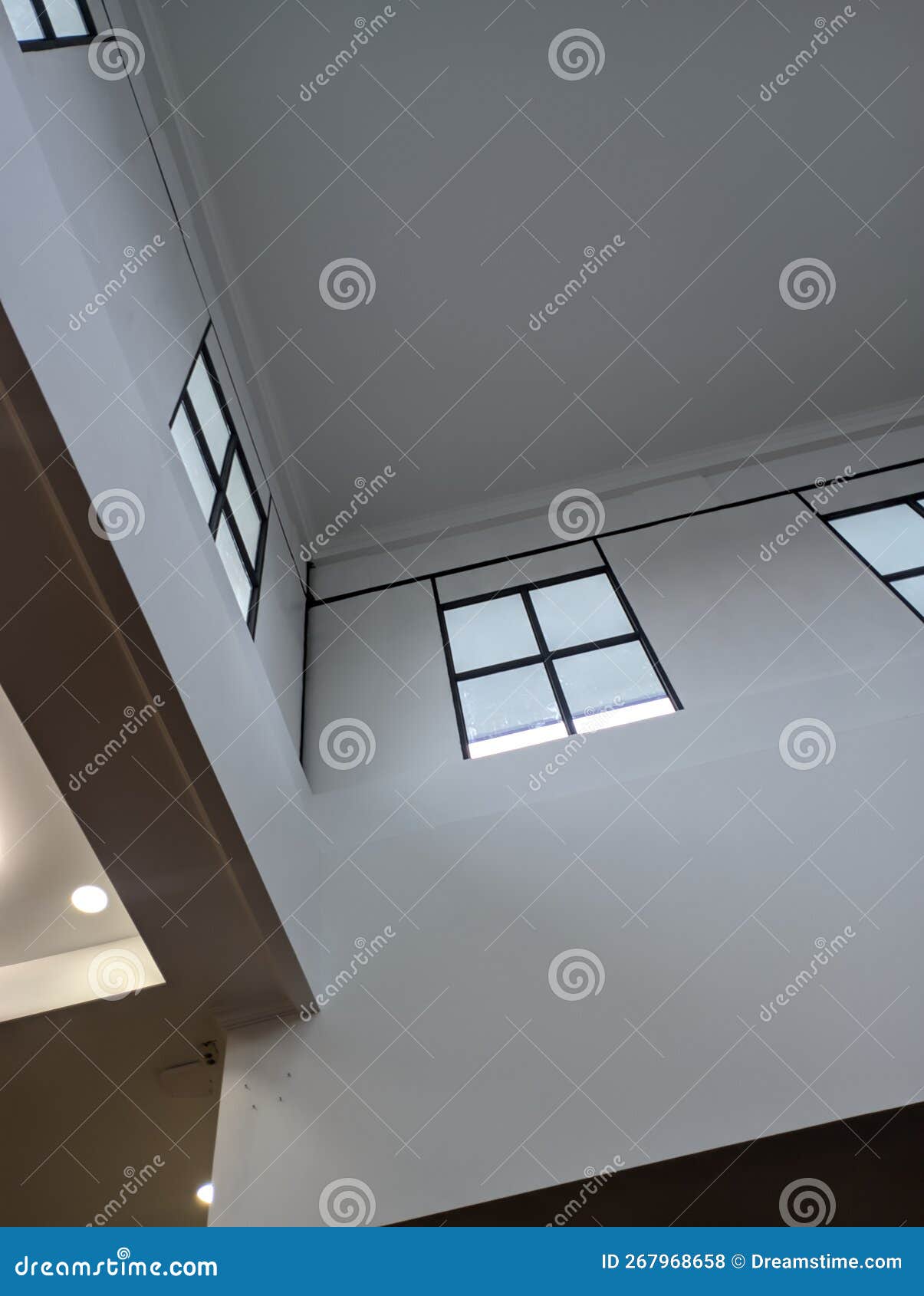 Photo of a Corner of a Room with a View of the Windows and Ceiling of a ...