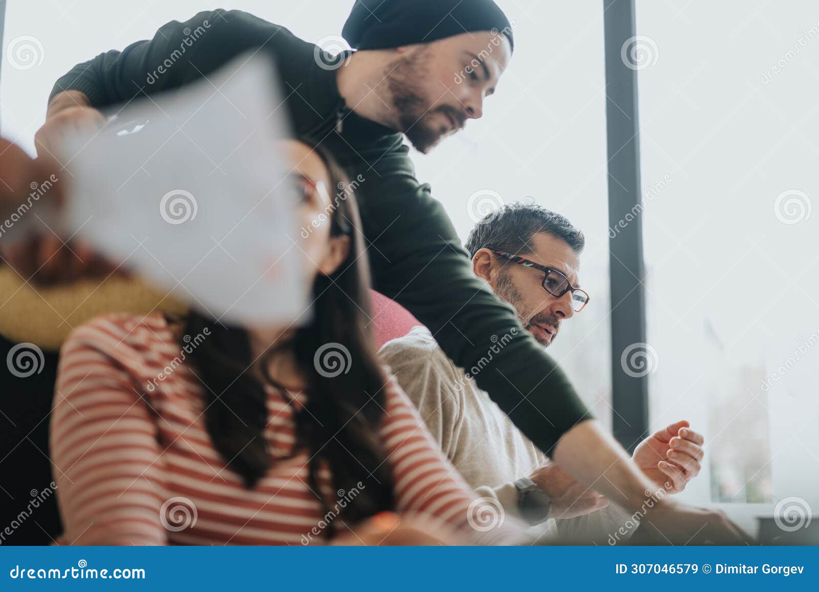 Photo of a Cross Generational Creative Team Intensely Discussing ...