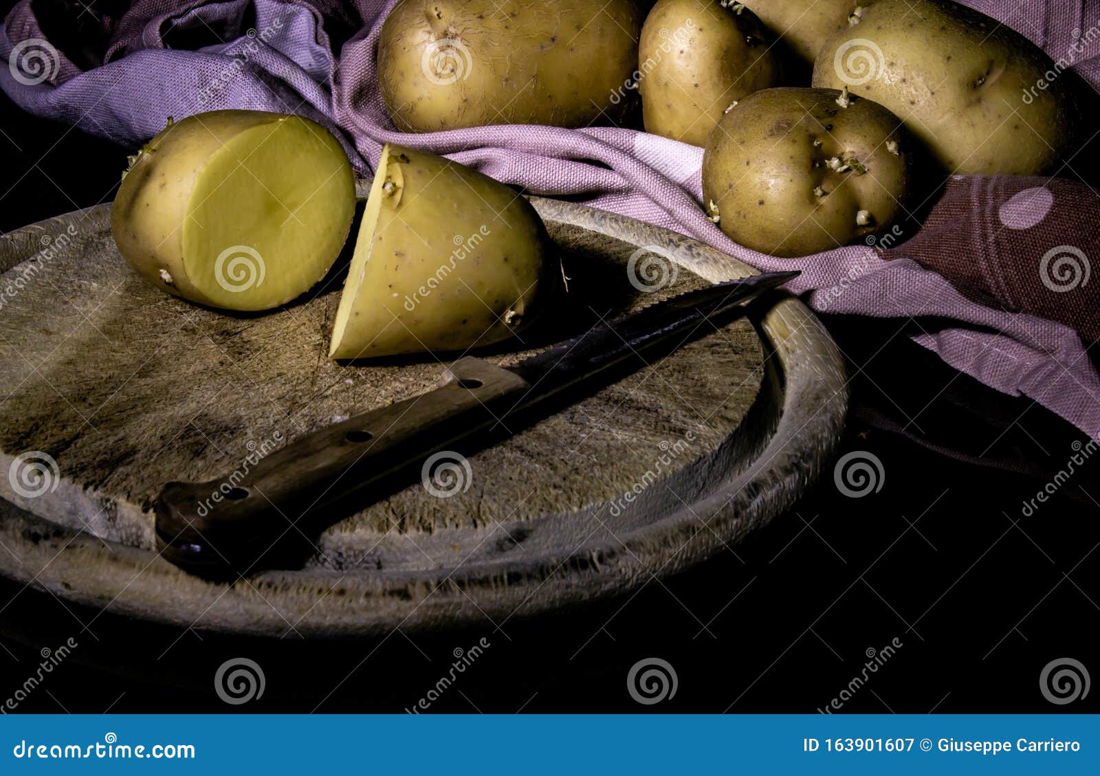 Photo Depicting Potatoes on a Plane with One Cut in Two on a Board ...