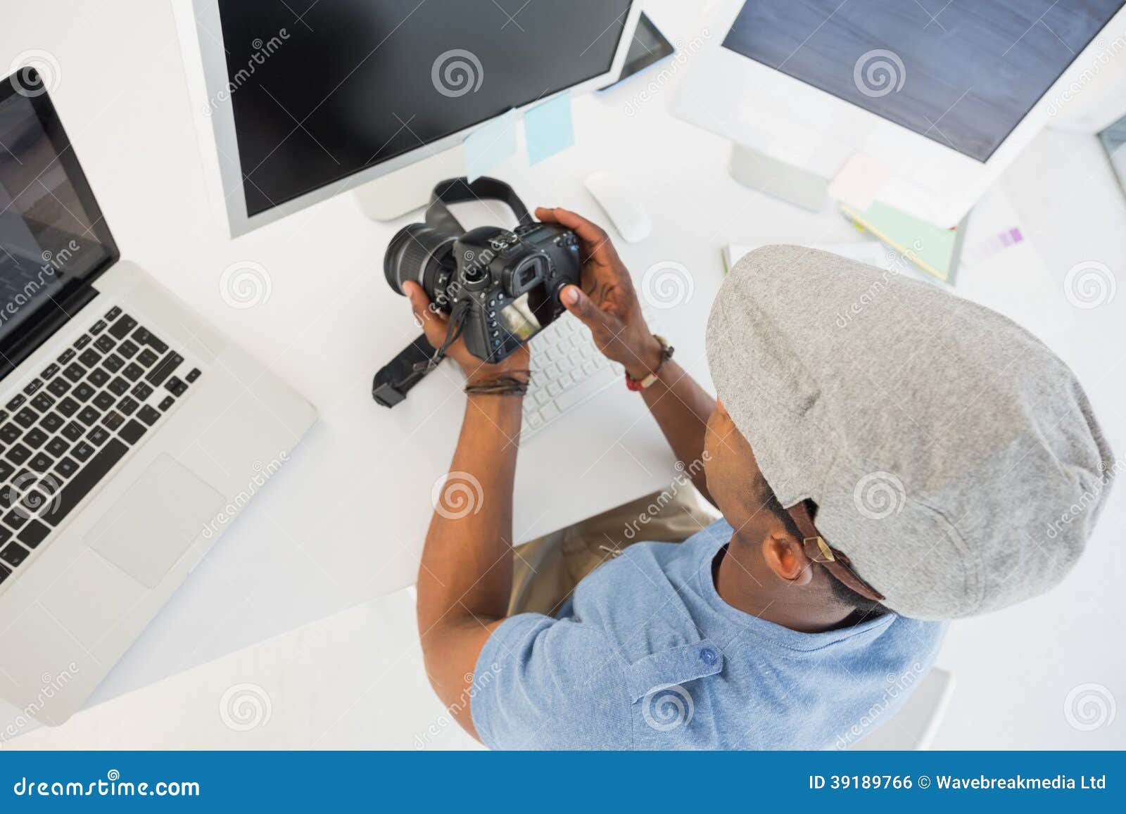 Photo Editor Looking at Digital Camera in Office Stock Photo - Image of ...