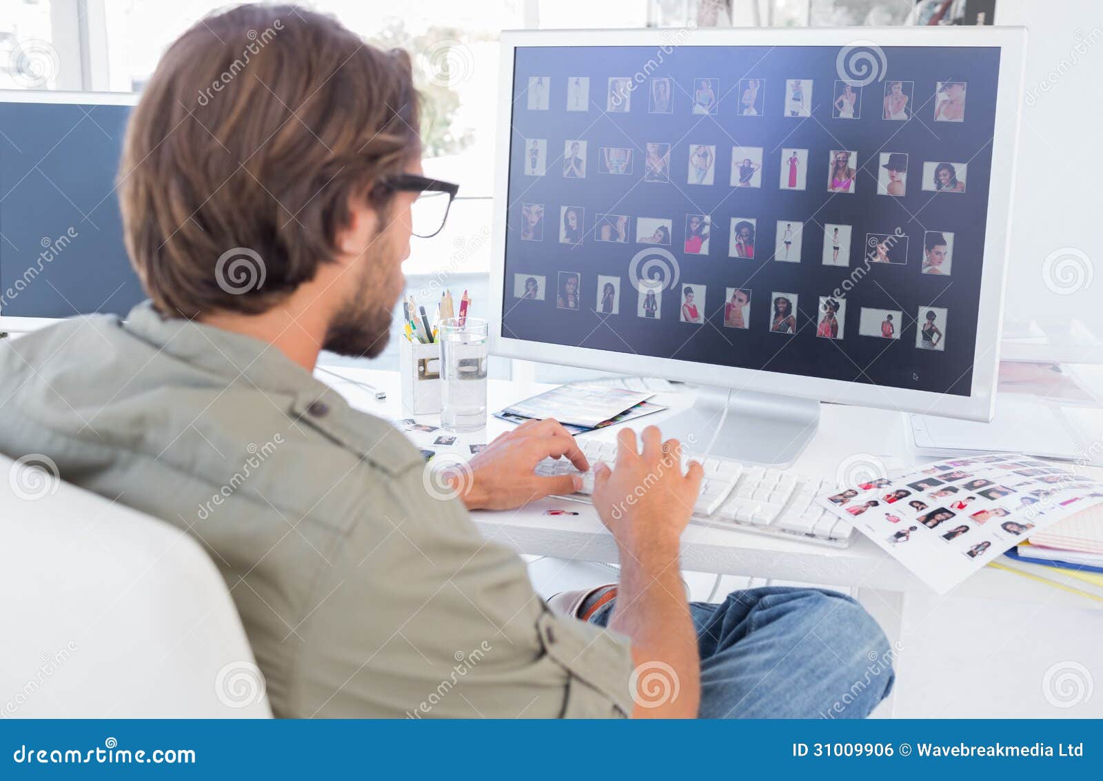 Photo Editor Looking at Thumbnails on Computer Stock Photo - Image of ...