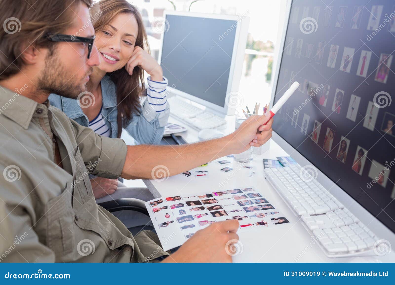 Photo Editor Pointing at Thumbnail on Screen Stock Image - Image of ...