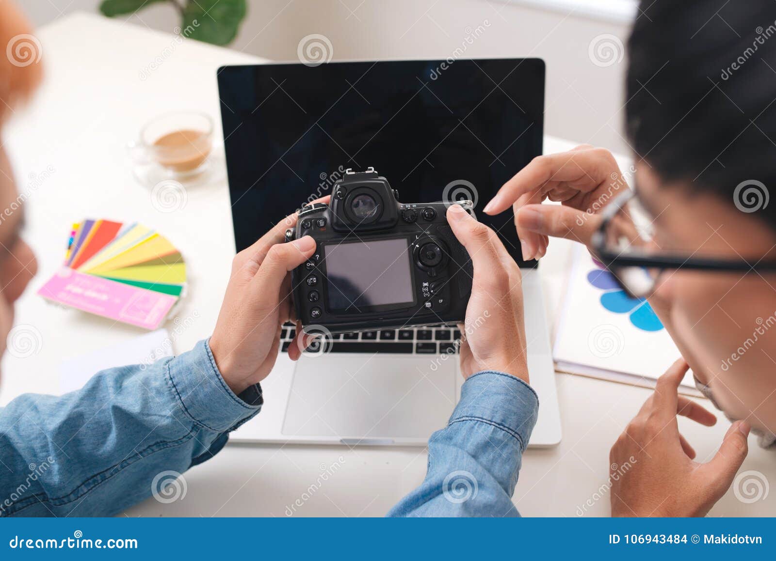 Photo Editors Looking at Camera in Studio Sitting on the Desk Stock ...