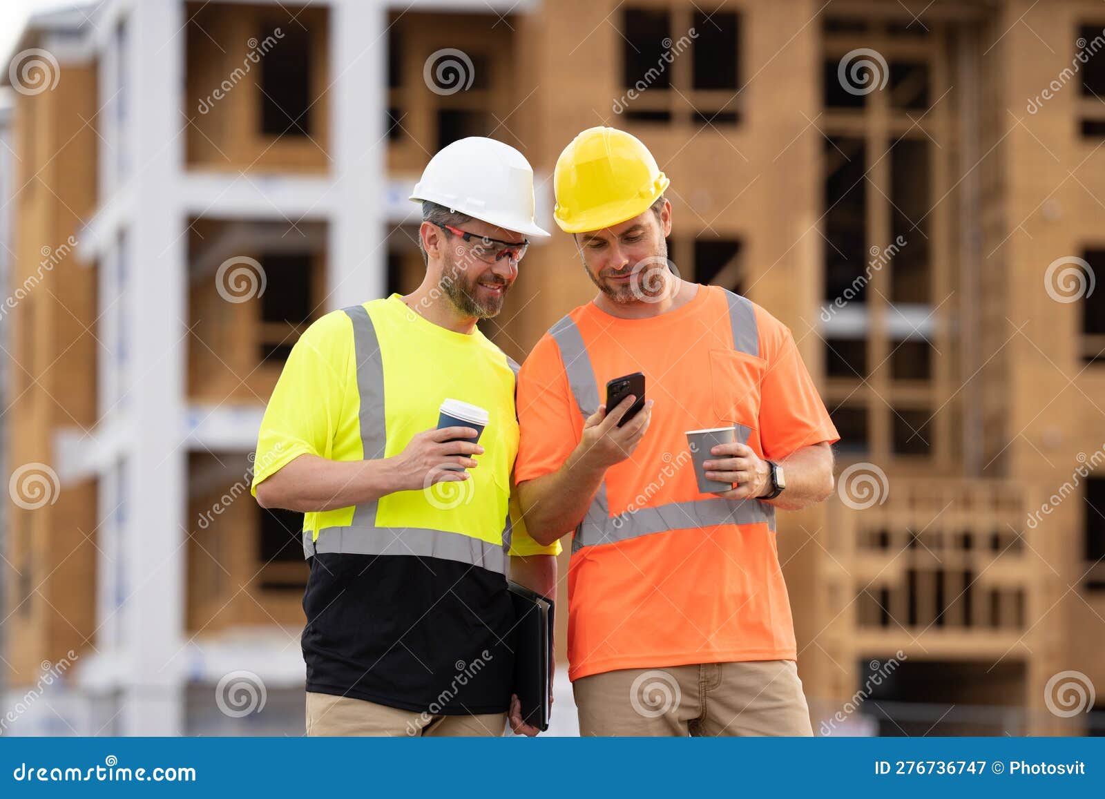 Photo of Engineer Men Using Phone at Construction Site. Engineer Men at ...