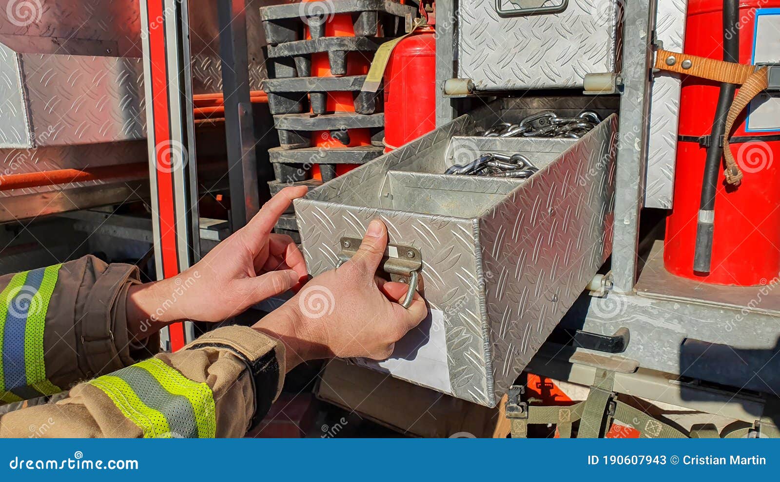 Photo of Firefighter Pulling Chains on Fire Truck Stock Image - Image ...