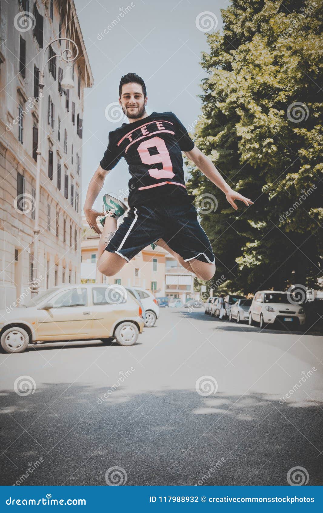 Photo Of A Guy Jumping On Road Picture. Image: 117988932