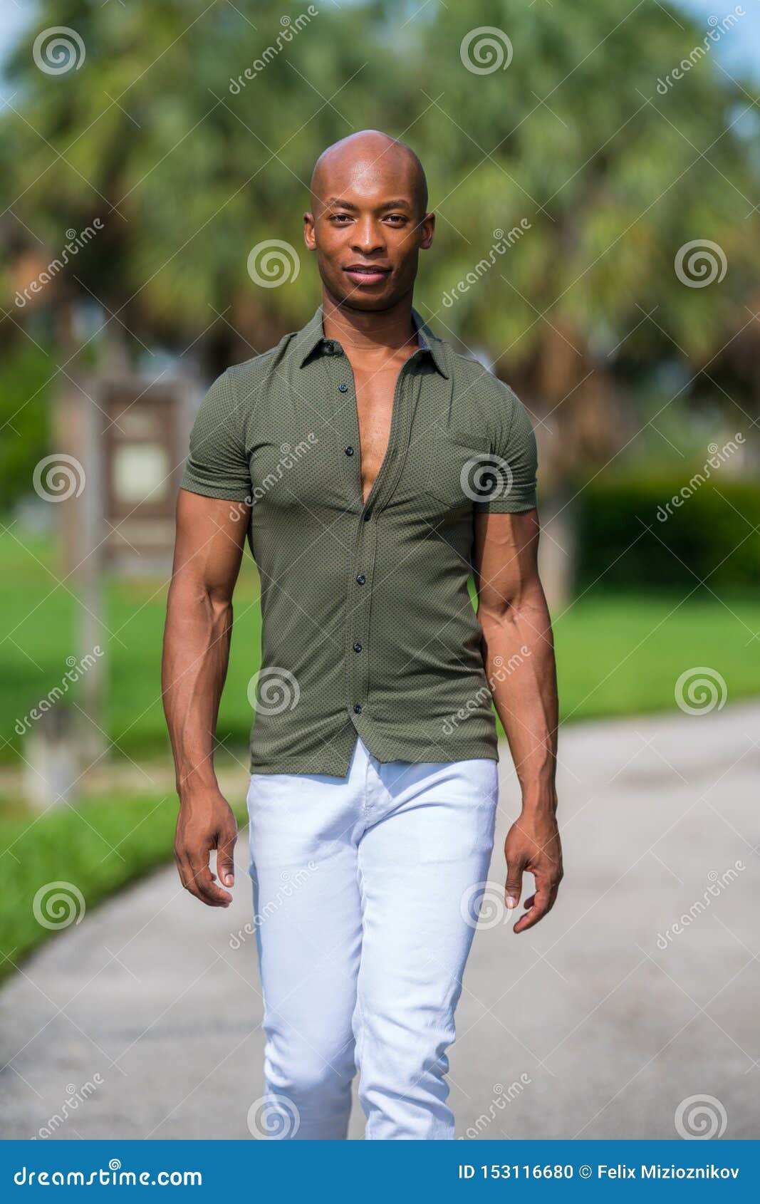 Photo of a Handsome Man Approaching the Camera an Outdoor Park Setting ...