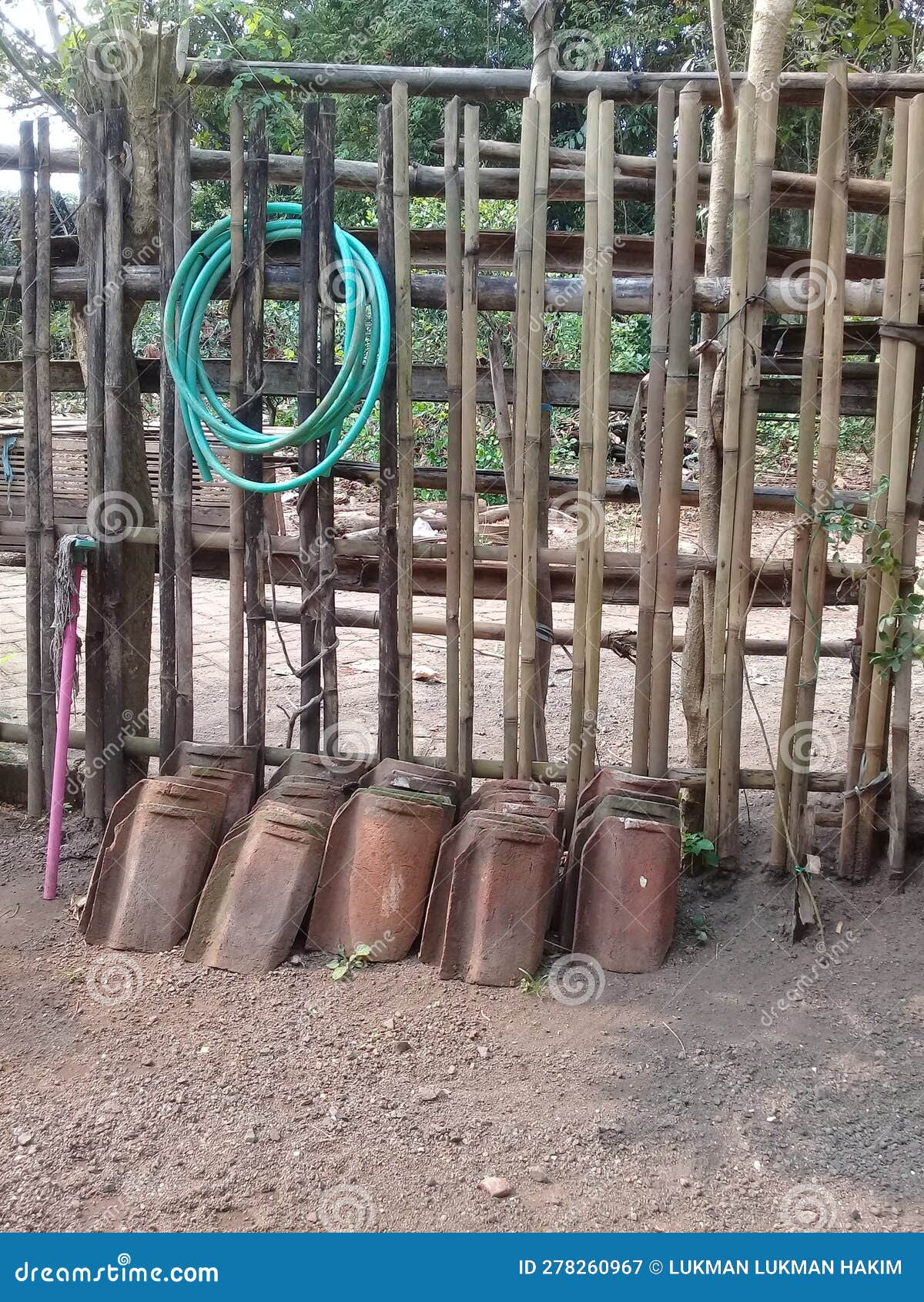 Photo of the Hose that is Hooked on the Bamboo Fence Stock Image ...